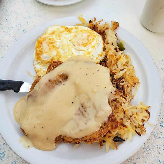 Country fried steak smothered in gravy alongside crispy hash browns and sunny-side-up eggs&mdash;the breakfast equivalent of a warm hug from your favorite aunt.