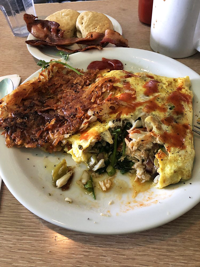 This isn't just an omelet&mdash;it's a masterpiece of eggs cradling fresh crab, with hash browns that achieve that elusive crispy-outside, tender-inside perfection.