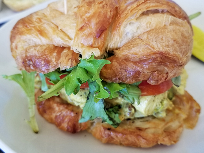 This croissant sandwich isn't just breakfast—it's architecture. Layers of fresh ingredients stacked between buttery, flaky perfection.