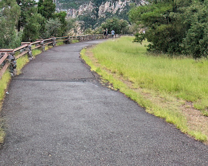 The gently curving pathway invites exploration along the rim, proving that sometimes the best views in life require just a few more steps.