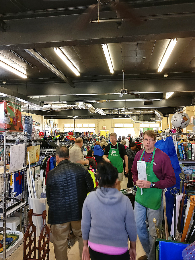 The true thrift store experience: fellow treasure hunters examining potential finds with the focused concentration of archaeologists at a dig site.