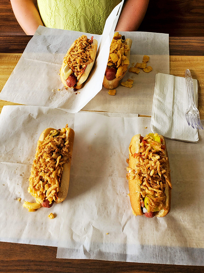 Four hot dogs lined up like edible soldiers, each one a testament to creative culinary genius.