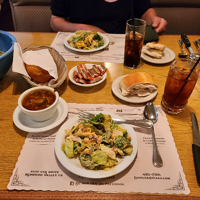 The spread before a meal begins – bread, salad, and iced tea setting the stage for the main event.