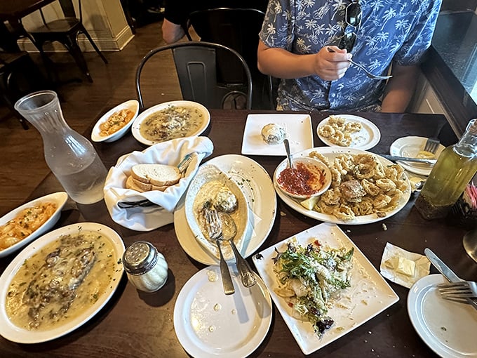 A table that tells stories of celebration. Multiple dishes, shared plates, and the kind of spread that makes you glad you wore stretchy pants.