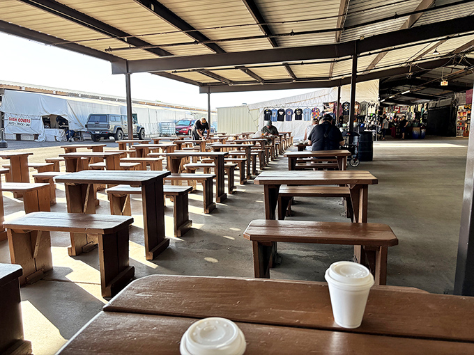 Simple wooden tables offer respite for weary shoppers. Two coffee cups suggest the universal truth: shopping is better with caffeine and conversation.