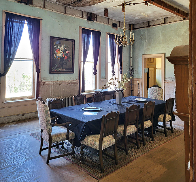The formal dining room's elegant decay creates a haunting beauty. That chandelier has seen more drama than a season of Downton Abbey.