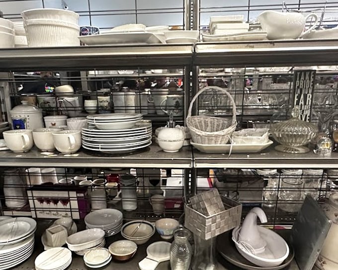 White dishes and glassware arranged like an archaeological exhibit of American dining habits. Every piece tells a domestic story.