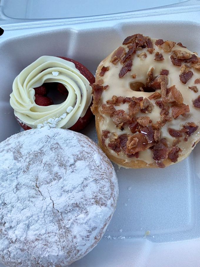 Decision paralysis has never been so delicious. Each donut in this trio tells a different story&mdash;powdered sugar poetry, bacon brilliance, and chocolate decadence.
