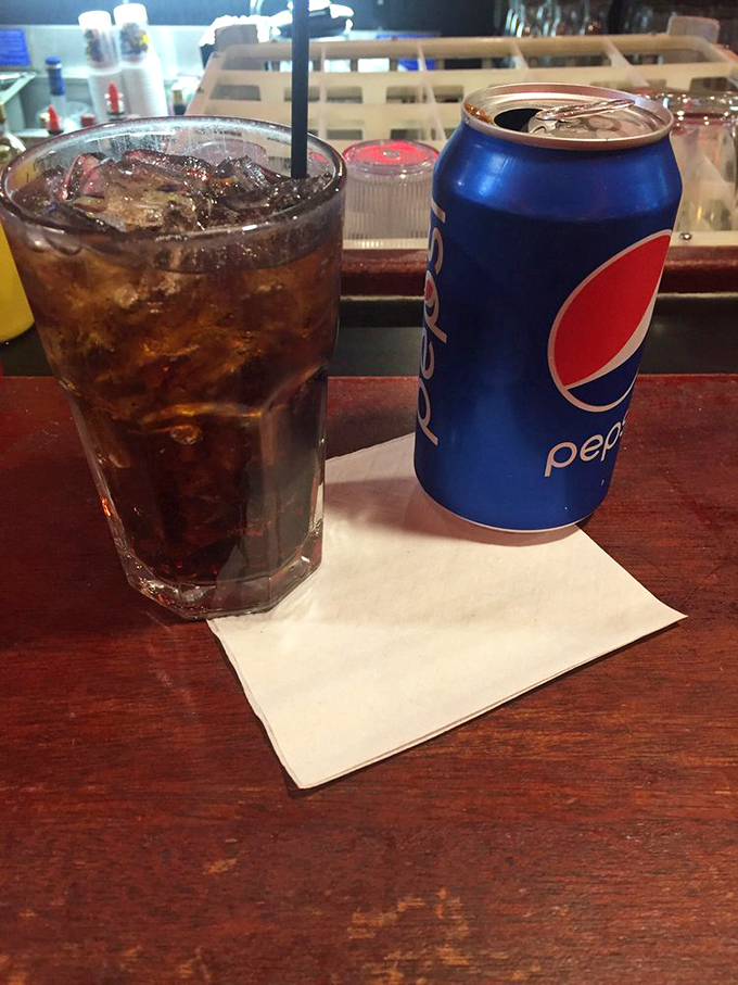 Sometimes happiness is as simple as a cold drink in a no-nonsense glass on a worn wooden bar top that's heard a thousand stories.