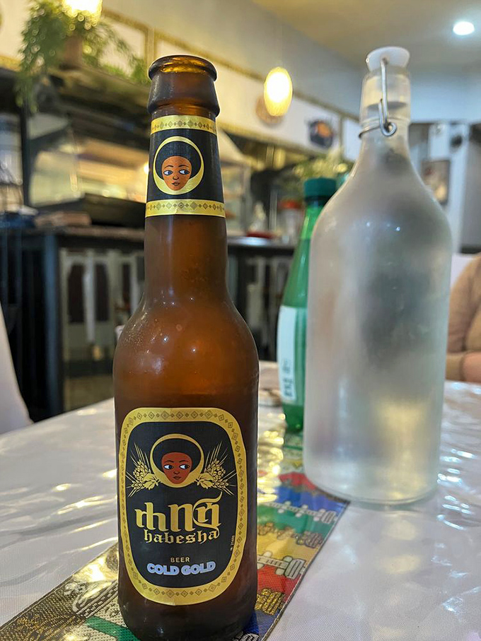Ethiopian beer brings a refreshing counterpoint to the meal's spicy notes, its distinctive label as colorful as the cuisine it accompanies.
