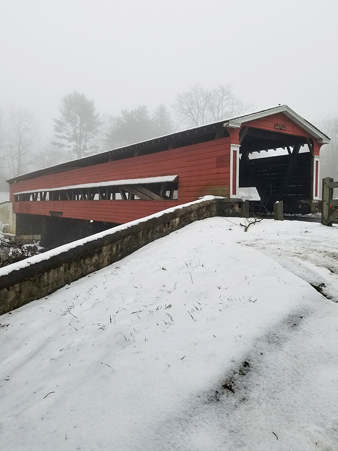 Winter transforms Smith's Bridge into a scene worthy of a holiday card, the red exterior popping dramatically against the misty, snow-dusted landscape.