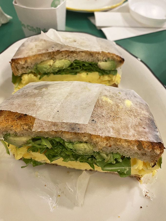 Sunshine on a plate&mdash;fluffy eggs, vibrant greens, and creamy avocado nestled between bread that's been toasted to golden perfection.
