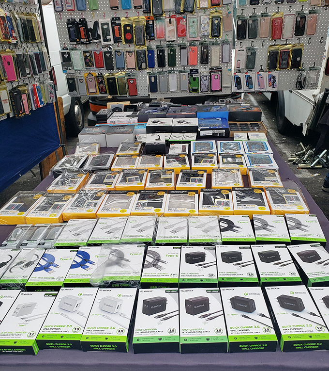 Phone accessory heaven! Every charger, case, and gadget known to modern humanity, arranged with the precision of a tech museum exhibit.