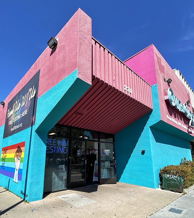 The entrance feels like walking into a Miami beach party that decided to open a thrift store. Free HIV testing sign makes the mission clear.