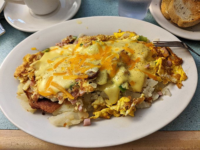 A skillet that could solve any problem – layers of eggs, potatoes, and melted cheese creating the ultimate breakfast therapy session.