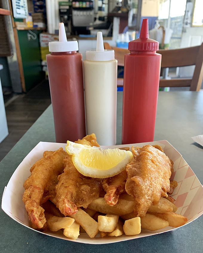 Fish and prawns with a lemon wedge – nature's flavor reset button. The condiment trio stands ready like culinary wingmen for your seafood adventure.