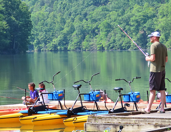 Patient anglers and colorful kayaks create the perfect lakeside tableau where time moves at fishing speed.