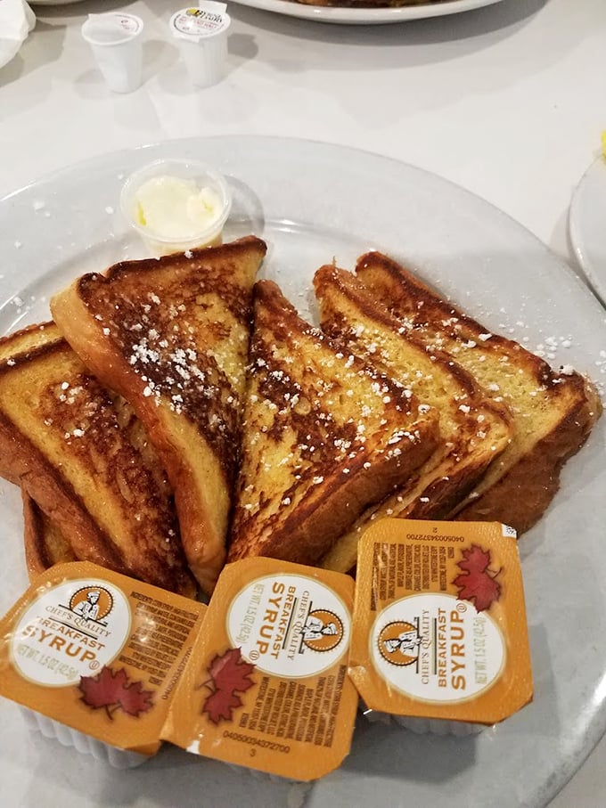 French toast dusted with powdered sugar and served with maple syrup. Breakfast or dessert? The line deliciously blurs with each perfect bite.
