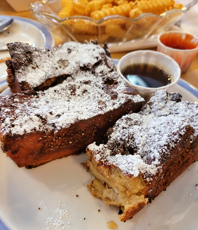 French toast that makes breakfast feel like dessert, dusted with powdered sugar snow and begging for that maple syrup drizzle.