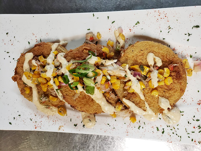 These aren't just fried green tomatoes—they're crispy Southern comfort topped with corn relish and a drizzle of sauce that tells a delicious story.