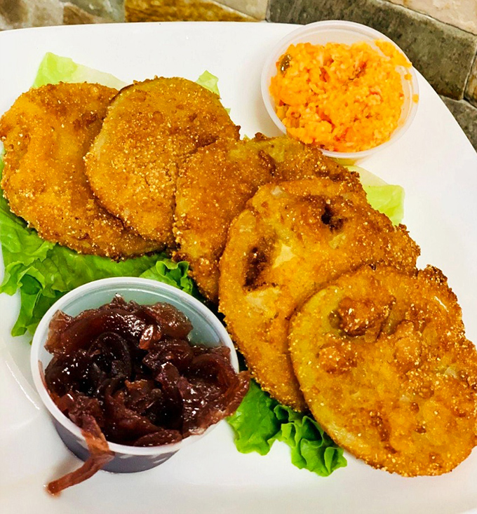 Fried green tomatoes: the South's gift to civilization. Crispy, tangy discs of joy served with house-made jam that'll make you want to write thank-you notes.