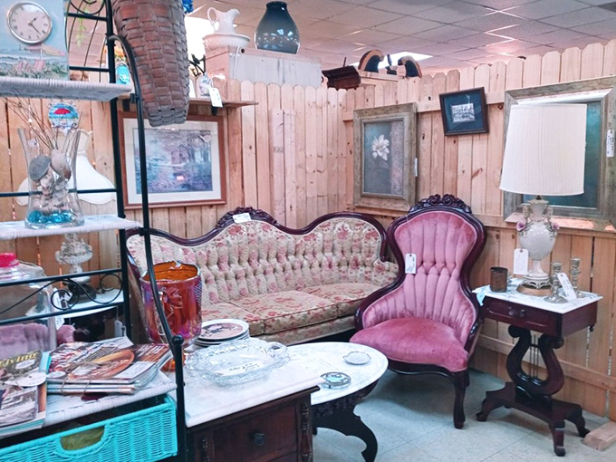 A Victorian sitting area that looks ready for gossiping over tea. That pink velvet chair has definitely heard some secrets in its day.