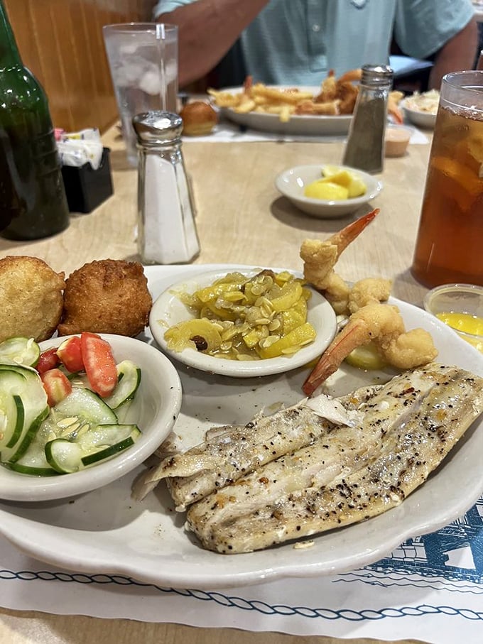 A seafood lover's dream plate: perfectly grilled fish, tender shrimp, and fresh sides that prove simple preparation lets quality ingredients shine.