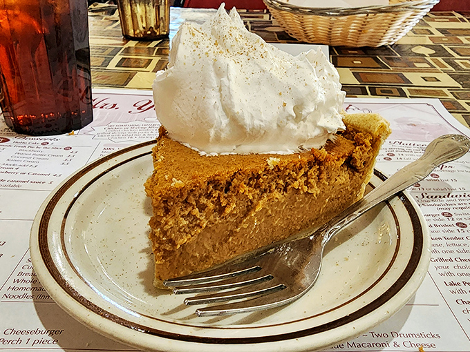 Pumpkin pie topped with a cloud of whipped cream&mdash;autumn on a plate, regardless of what season it actually is outside.