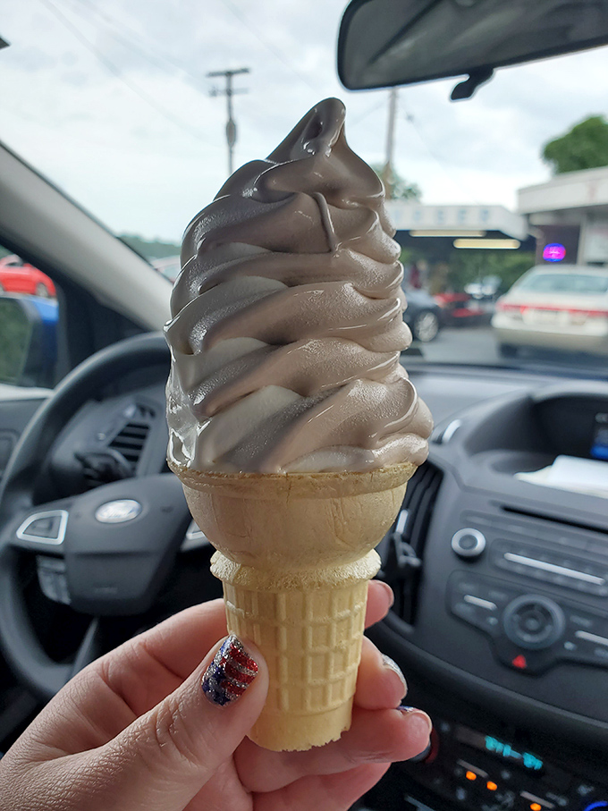 Soft-serve swirled to gravity-defying heights. This chocolate cone isn't just dessert—it's an architectural achievement you can eat.
