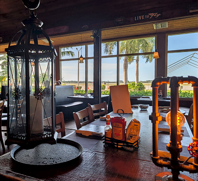 Tables with a view! Palm trees, blue skies, and the occasional aircraft create the perfect backdrop for a meal that feels like a mini-vacation.