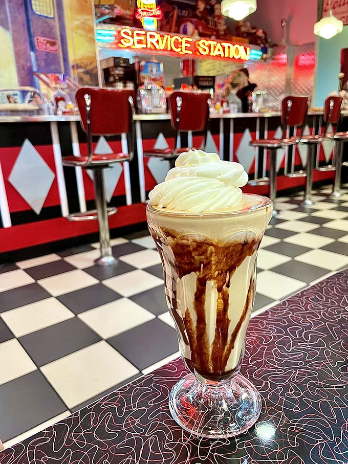 The chocolate milkshake stands tall and proud, its glass walls barely containing the creamy magnificence within. This is why straws were invented.