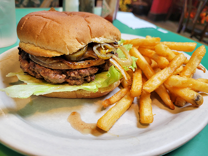 A burger that doesn't need fancy toppings to impress, just honest grilling and a perfect ratio of meat to fixings. Those fries look like they're auditioning for a food commercial.