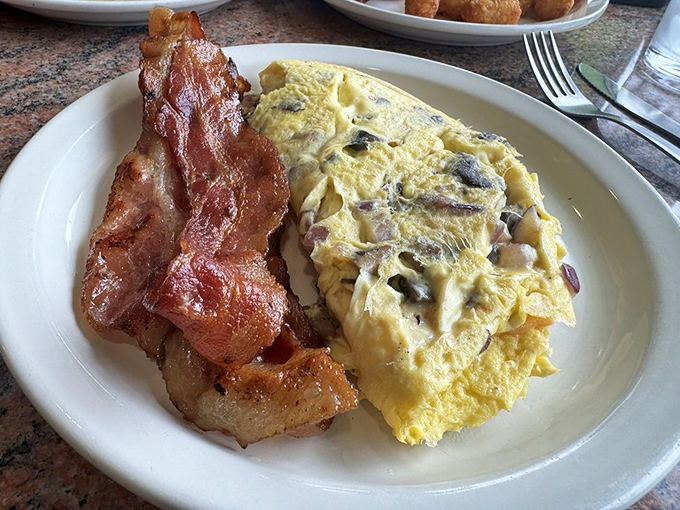 An omelet that doesn't skimp on fillings, paired with perfectly crisped bacon&mdash;this is breakfast that respects your hunger and your time.