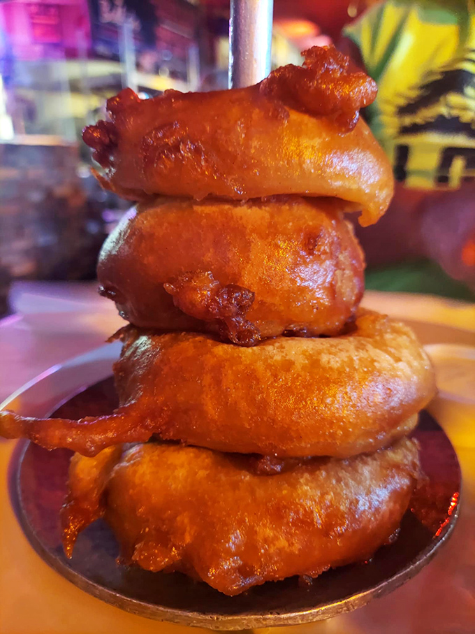 These aren't just onion rings &ndash; they're golden halos of crispy perfection stacked like the Tower of Pisa, only this tower is meant to topple straight into your mouth.