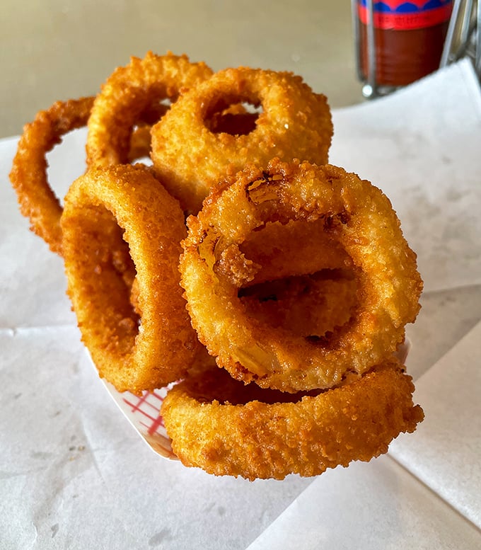 Onion rings with the structural integrity of Olympic gold&mdash;crispy armor protecting sweet, tender onion within. Worth every calorie and then some.