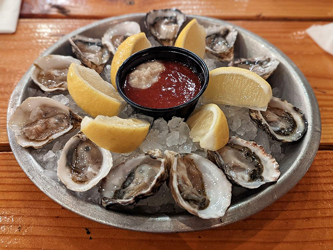 Oysters arranged like a pearl necklace on ice, with lemon wedges standing by for duty. The ocean's perfect appetizer&mdash;briny, fresh, and unapologetically authentic.