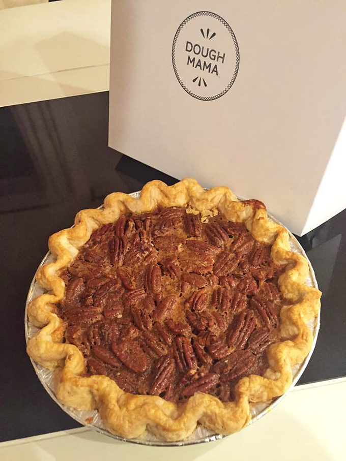 A pecan pie so perfect it belongs in a museum. That wavy golden crust and glistening pecan-studded filling is what dessert dreams are made of.