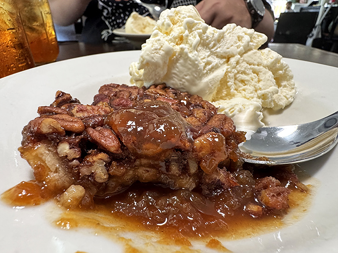 Pecan pie that makes you understand why people write songs about Southern desserts. Gooey, nutty perfection crowned with vanilla ice cream melting into sweet surrender.