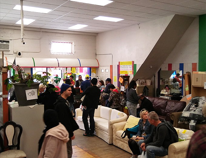 A bustling scene where shoppers examine potential treasures with the careful consideration of museum curators deciding on a new exhibit.