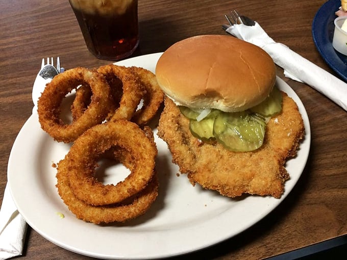 The legendary pork tenderloin&mdash;where the meat extends beyond the bun like Indiana's version of solar eclipse. Those onion rings aren't just sidekicks; they're co-stars.