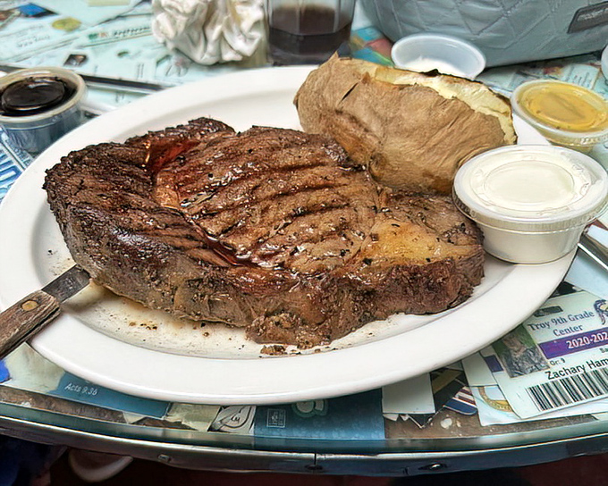 This steak isn't just resting on the plate&mdash;it's posing for its glamour shot. The grill marks are like nature's way of saying "you're welcome."