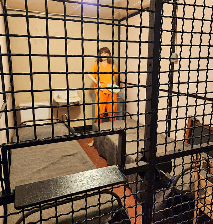 A mannequin prisoner in bright orange stands as a silent reminder of the jail's purpose, making modern jumpsuits look positively fashionable.