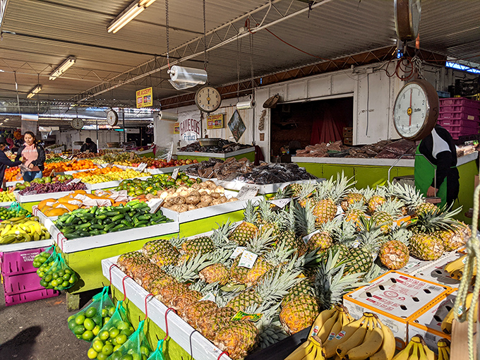 Nature's candy counter! This produce stand bursts with tropical treasures and everyday essentials, all looking fresher than your average supermarket fare.