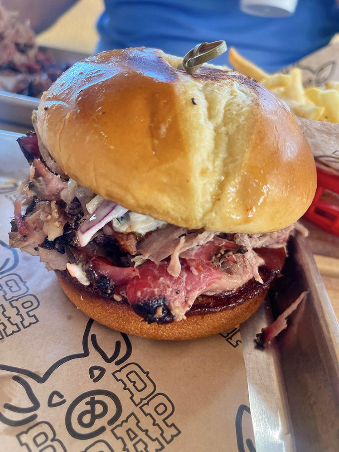 This pulled pork sandwich isn't just a meal, it's an event. The kind that requires strategic napkin deployment and zero distractions.