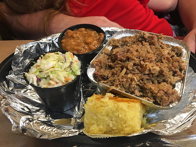This pulled pork platter isn't just food&mdash;it's edible evidence that good things come to those who smoke low and slow. The sides aren't afterthoughts; they're co-stars.