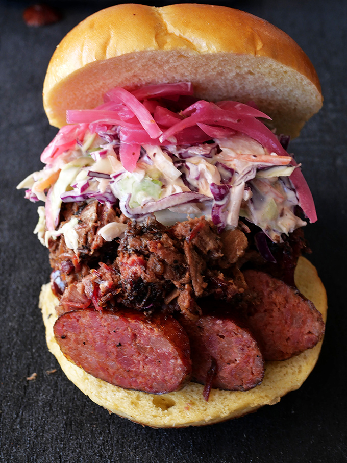 This sandwich doesn't just satisfy hunger&mdash;it's a towering achievement of meat, slaw, and pickled onions in perfect harmony.