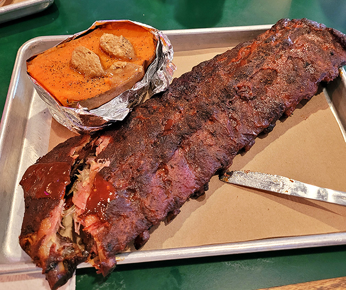 Behold the rack of ribs that launched a thousand road trips, with a sweet potato sidekick that refuses to be overshadowed.
