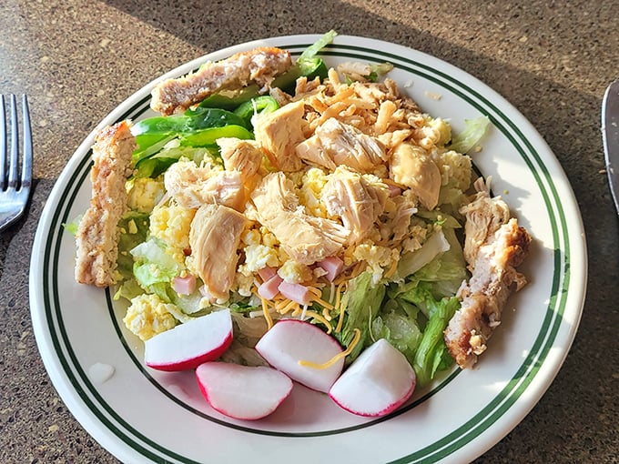 A colorful salad that proves vegetables can find happiness at a comfort food restaurant, especially when topped with perfectly seasoned chicken.
