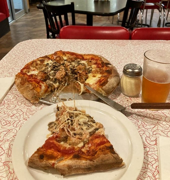 Witness the perfect marriage of sausage and mushroom atop a canvas of cheese—a relationship more harmonious than most Hollywood romances.