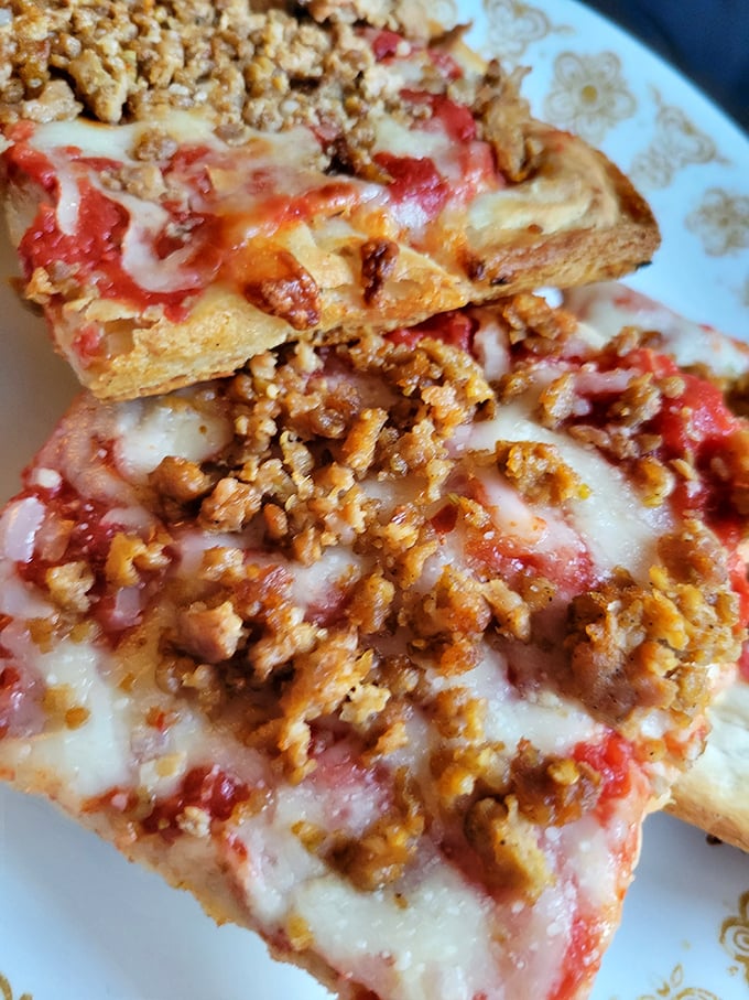The sausage pizza features perfectly seasoned crumbles that caramelize slightly at the edges. Diet plans have been abandoned for less.